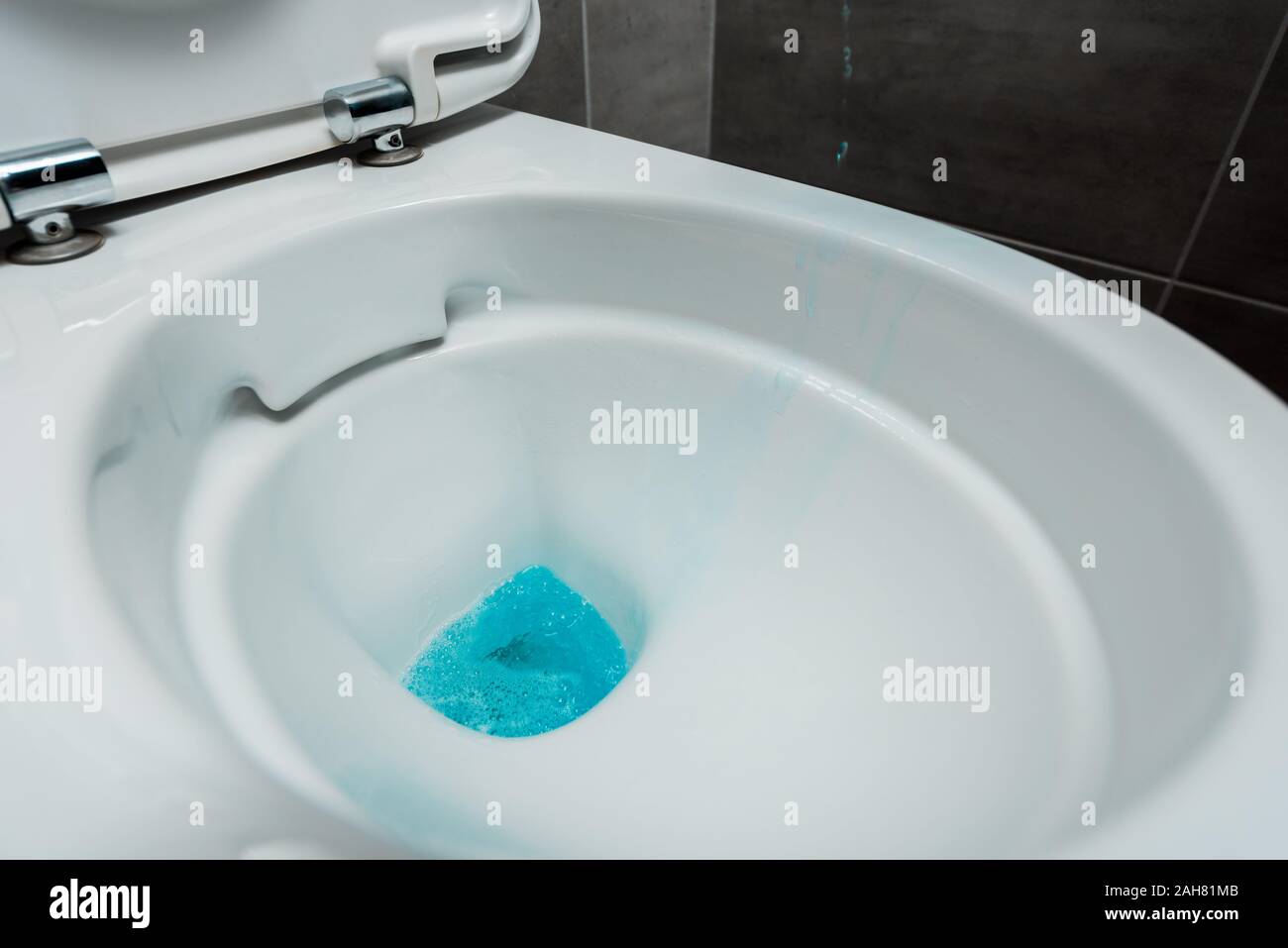 close up view of blue liquid detergent in ceramic clean toilet bowl in ...