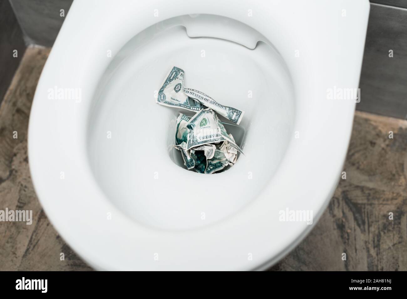 top view of dollar banknotes in toilet bowl in modern restroom Stock ...