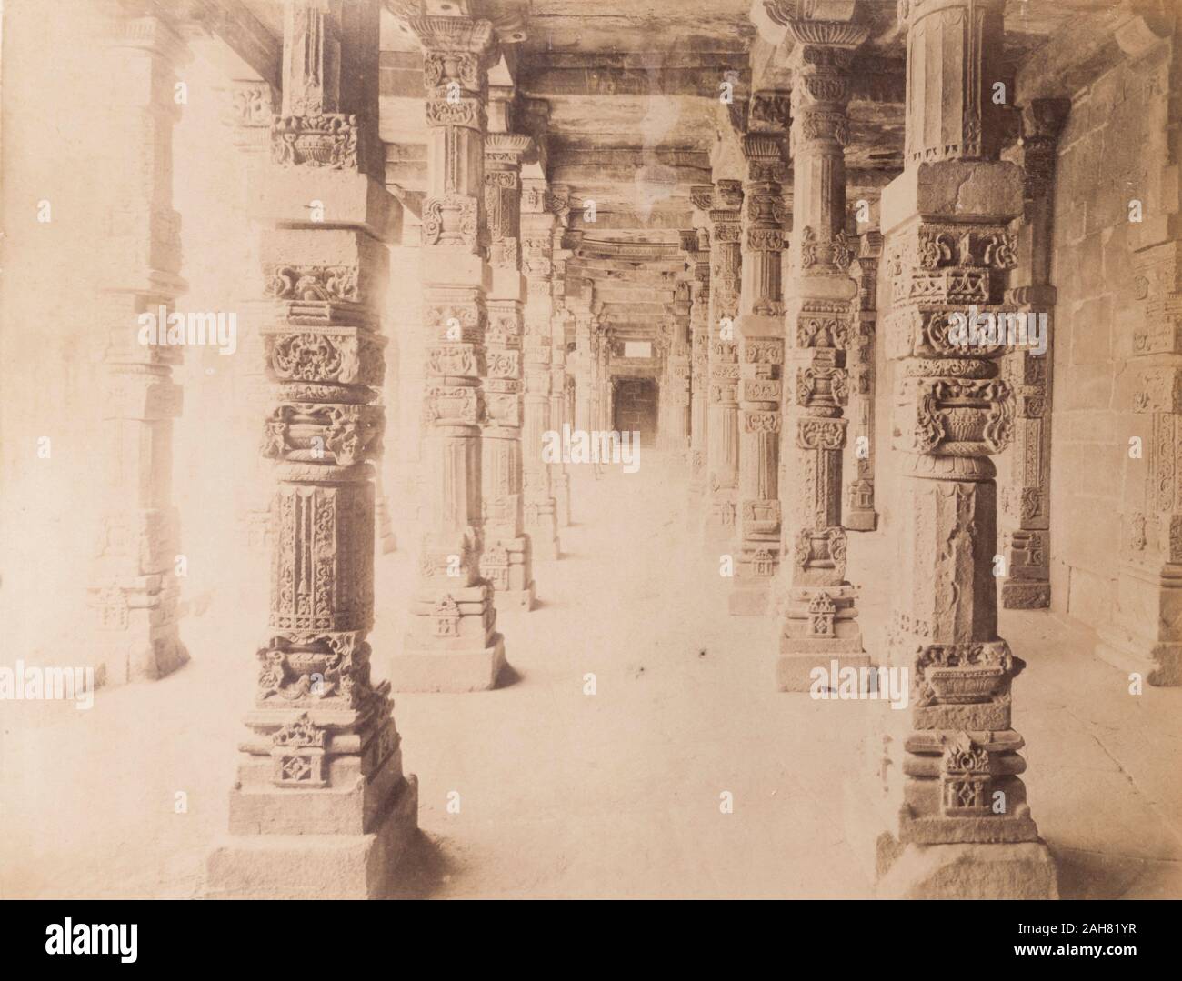 India, Intricately carved stone pillars line a passageway at the Quwwat ...