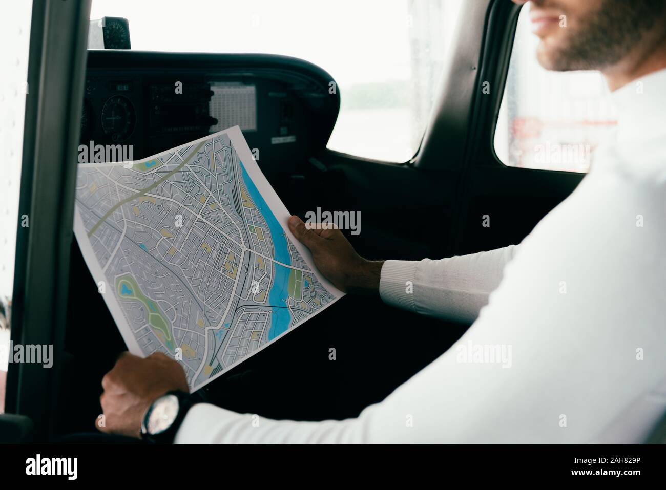 partial view of pilot holding map in plane Stock Photo - Alamy