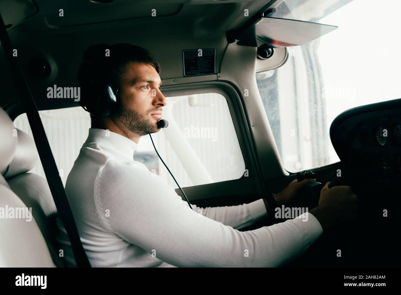 focused handsome bearded pilot in headset in plane Stock Photo - Alamy