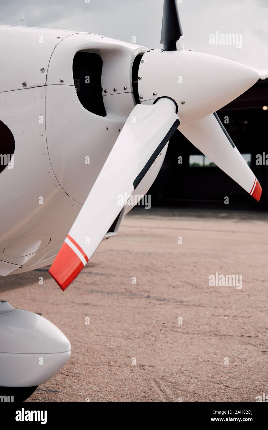 white plane with big propeller on ground under sky Stock Photo - Alamy