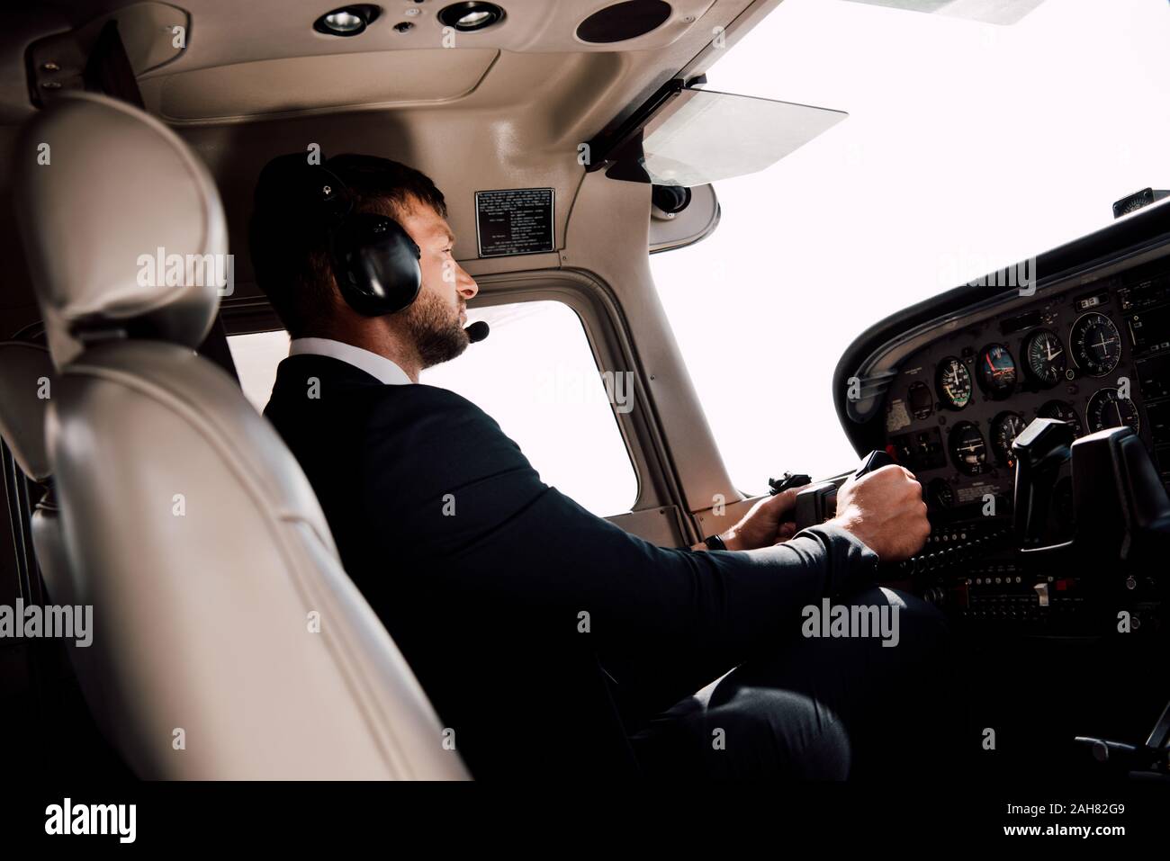 pilot in formal wear sitting in plane and holding Stock Photo - Alamy