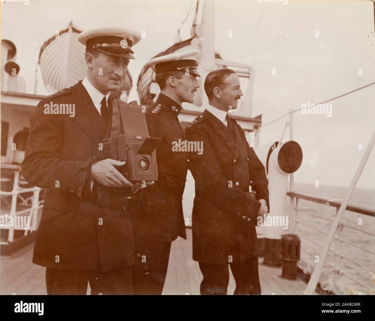 Two British naval officers admire the view from the deck of S.S ...