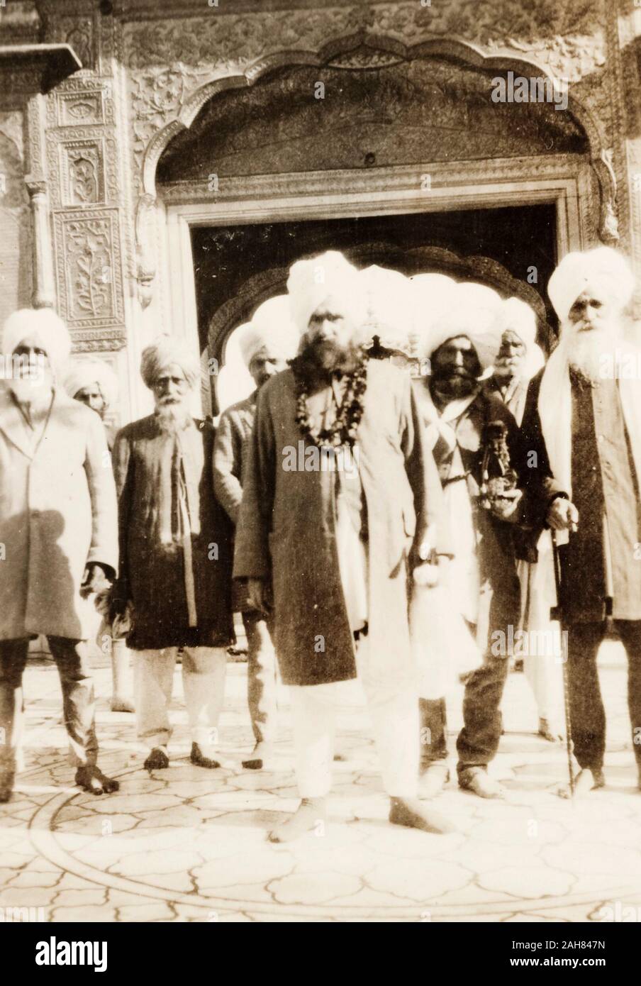 India, A group of Sikh men stand in front of an ornate archway at the ...