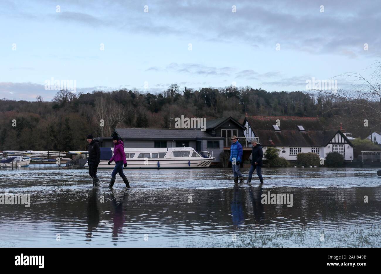 Walkers wade along a flooded towpath in Henley-on-Thames, Oxfordshire ...