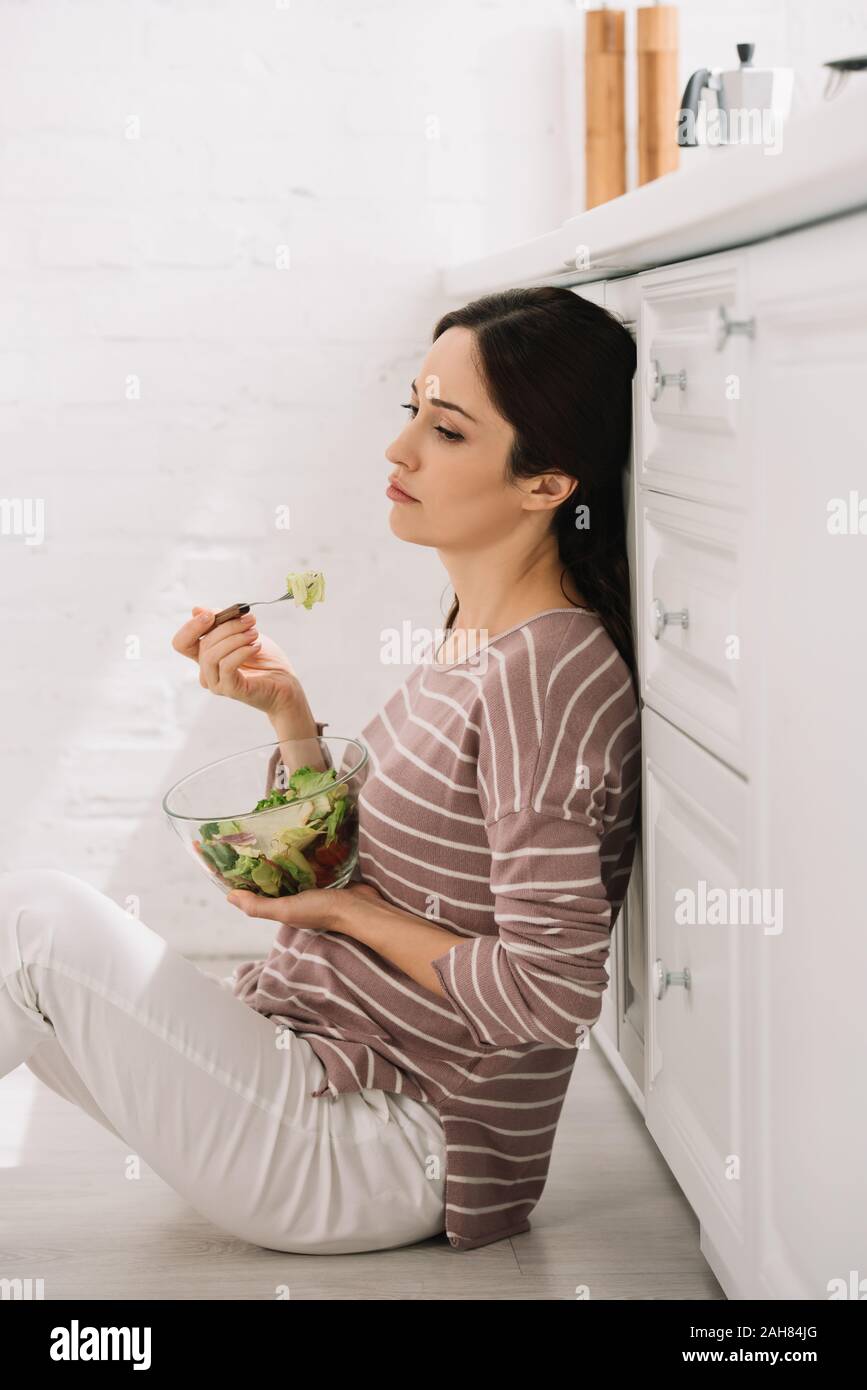Sad woman eating salad hi-res stock photography and images - Alamy