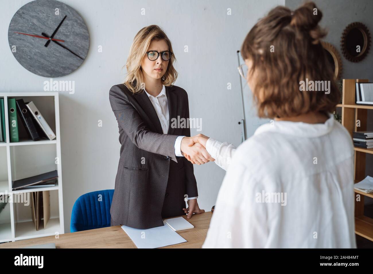 Two Businesswomen Shaking Hands In Office Stock Photo - Alamy