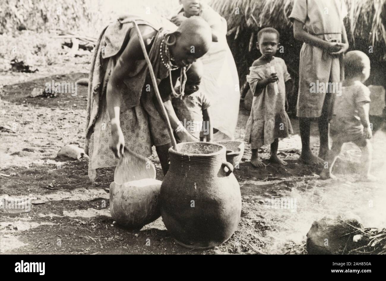Kenya, A Kikuyu woman outdoors at a family pottery makes a clay pot, a ...