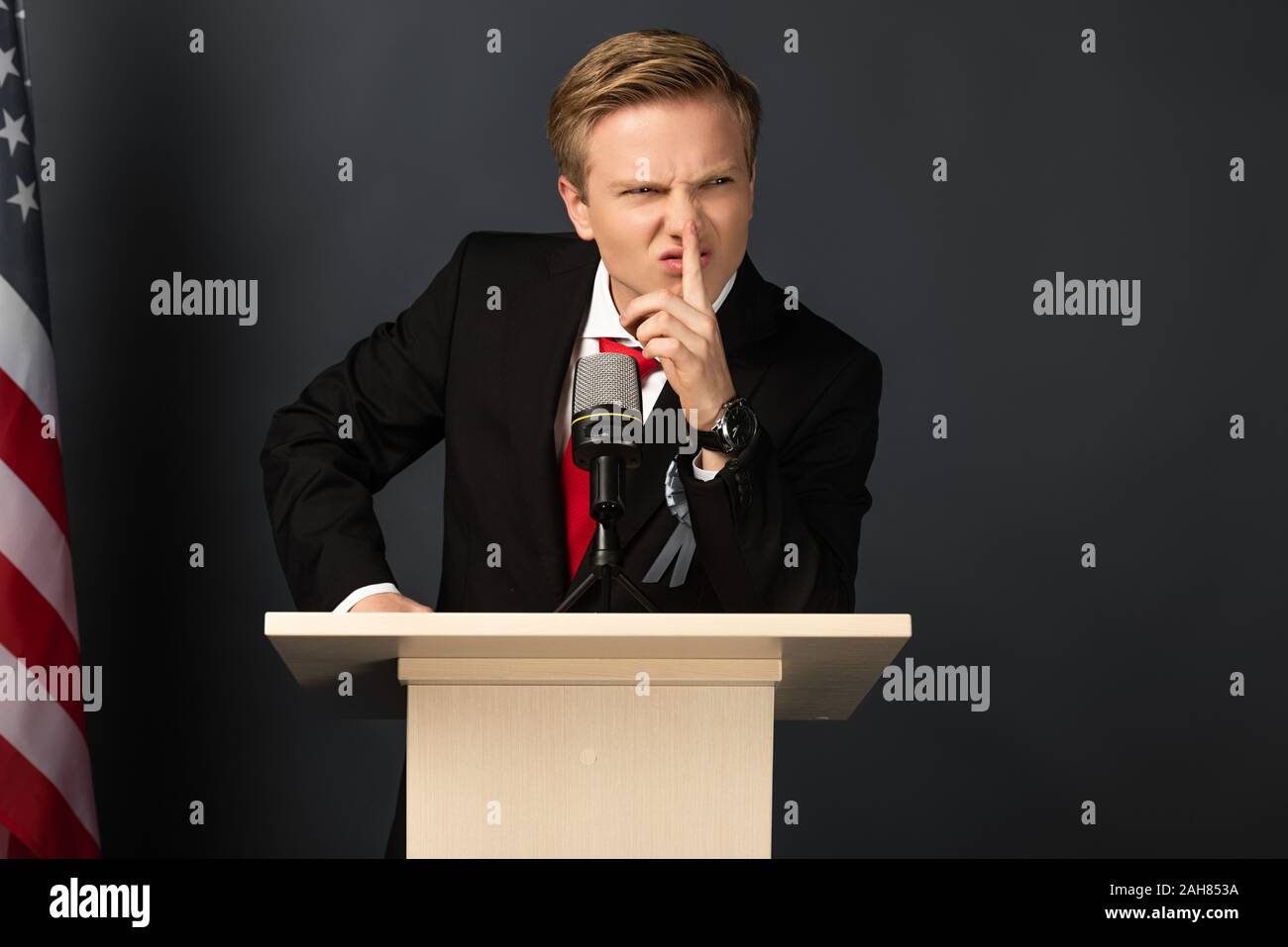 KYIV, UKRAINE - OCTOBER 18, 2019: displeased emotional man showing shh ...
