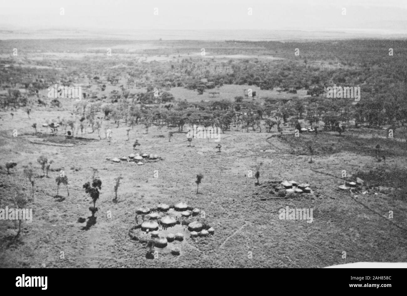 Kenya, Clusters of huts comprise a Luo settlement on the Kano plains ...