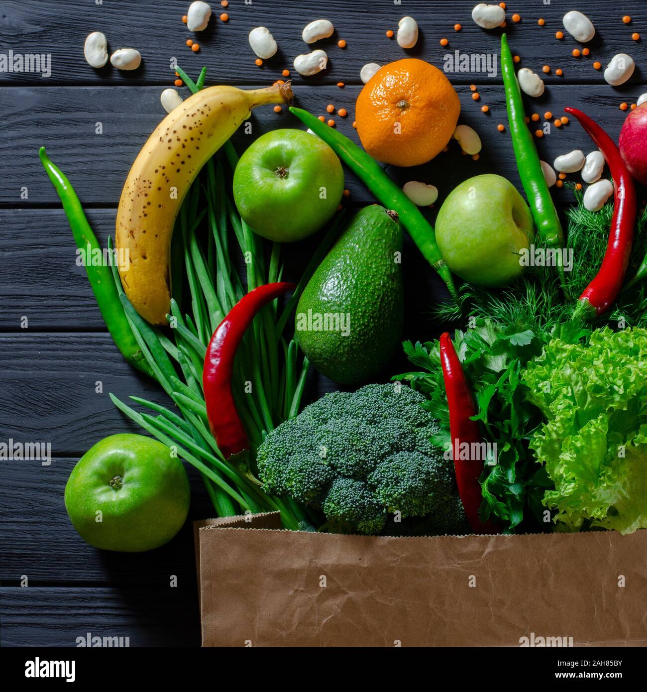 Top view paper bag of different fresh health food on white wooden ...