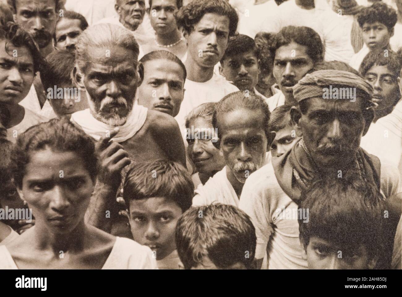 Sri LankaCeylon, A tightly packed crowd of people gaze into the camera ...