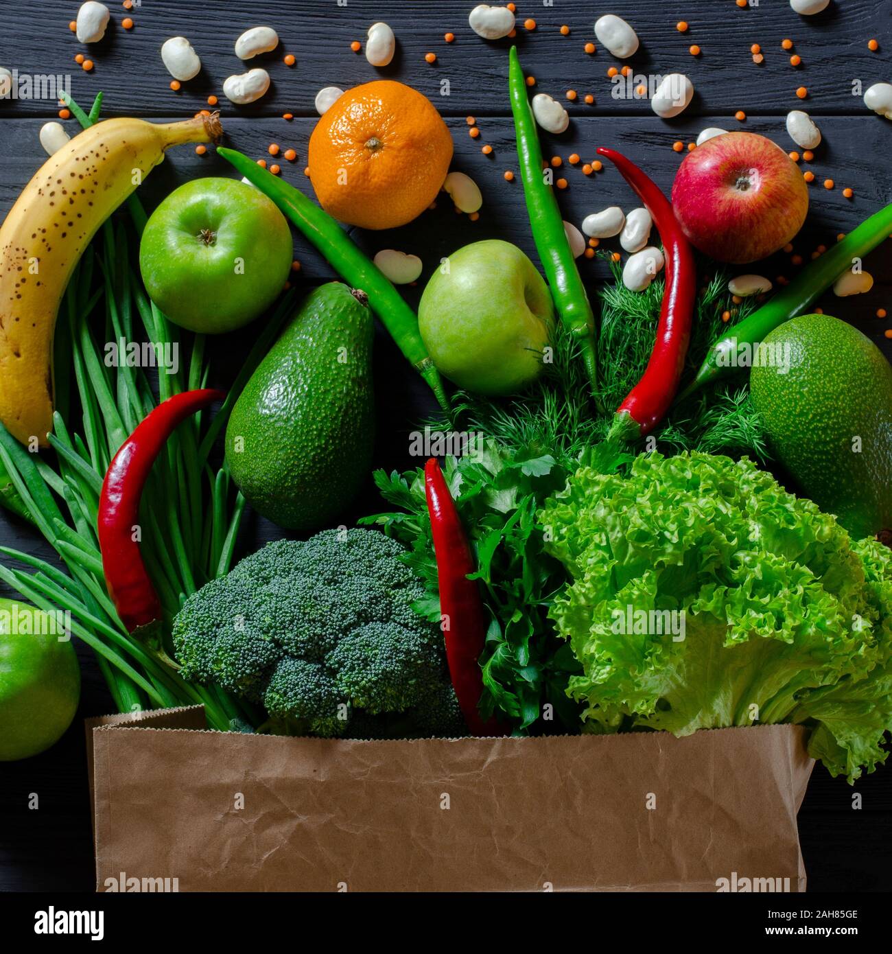 Top view paper bag of different fresh health food on white wooden ...