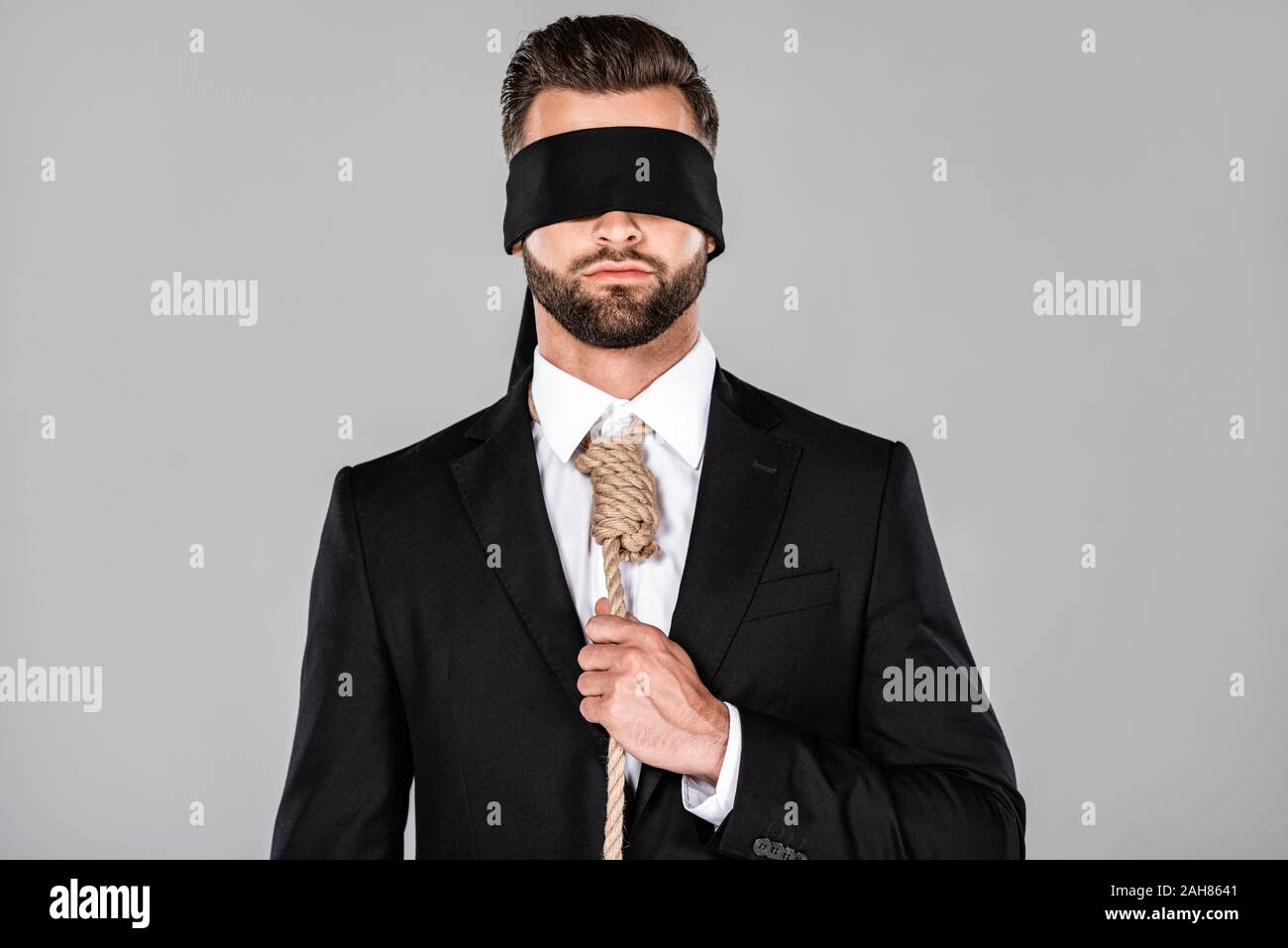 blindfolded businessman in black suit with noose on neck isolated on ...