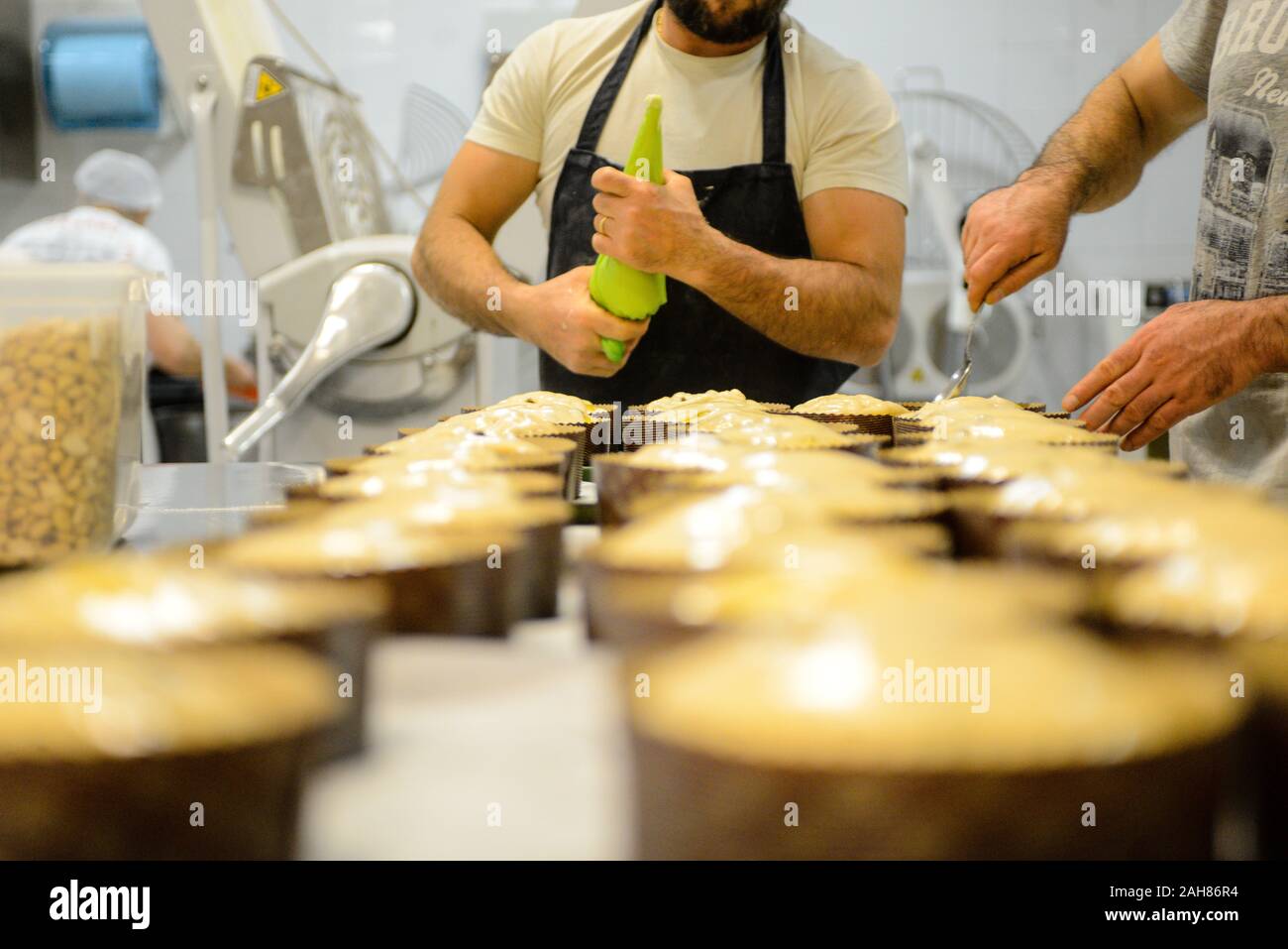 pasty chef strong adult man chef preparing and decorating panettone for ...