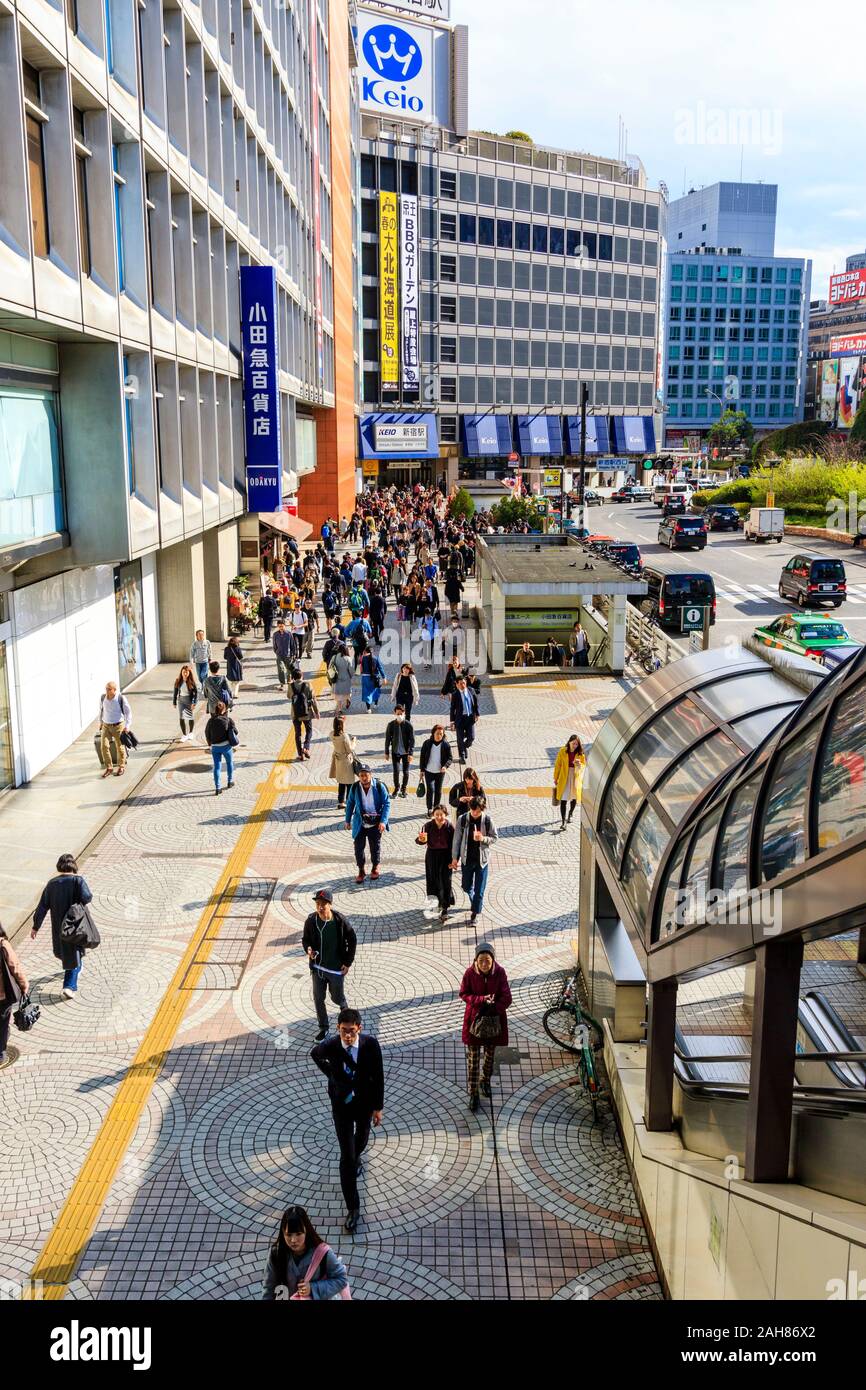 Daytime overhead view along the crowded pavement outside the Odakyu ...
