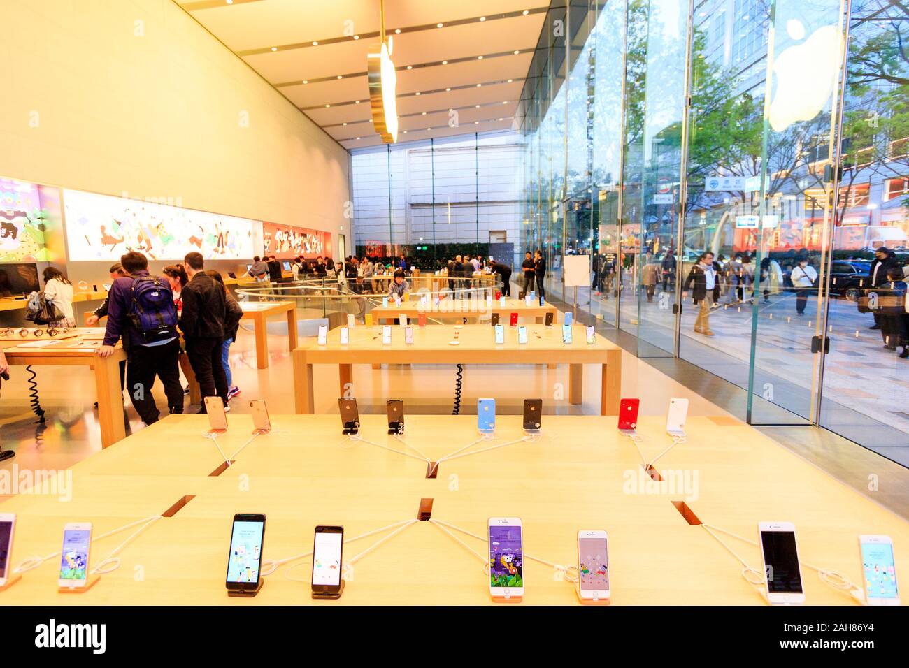 Interior of the Apple store in Omotesando, Tokyo. People looking at the ...