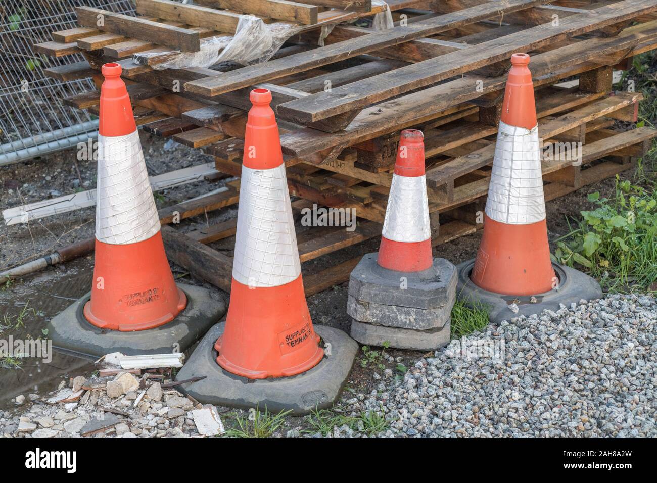 Collection of four road cones separating off an area from pedestrian ...