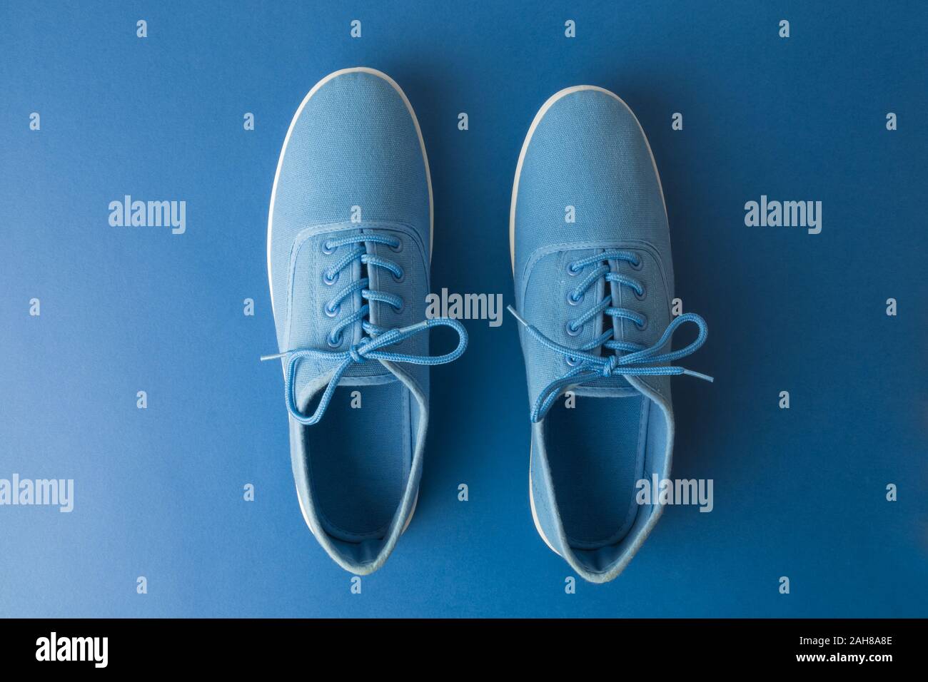 Pair of shoes on classic blue background minimal creative clothing and ...