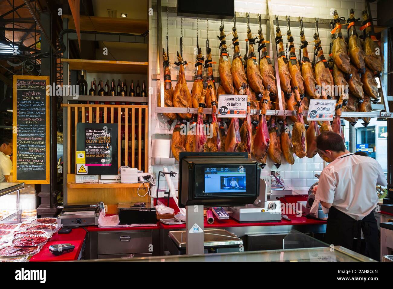 A man behind the counter at a Charcuterie in Madrid, Spain Stock Photo ...