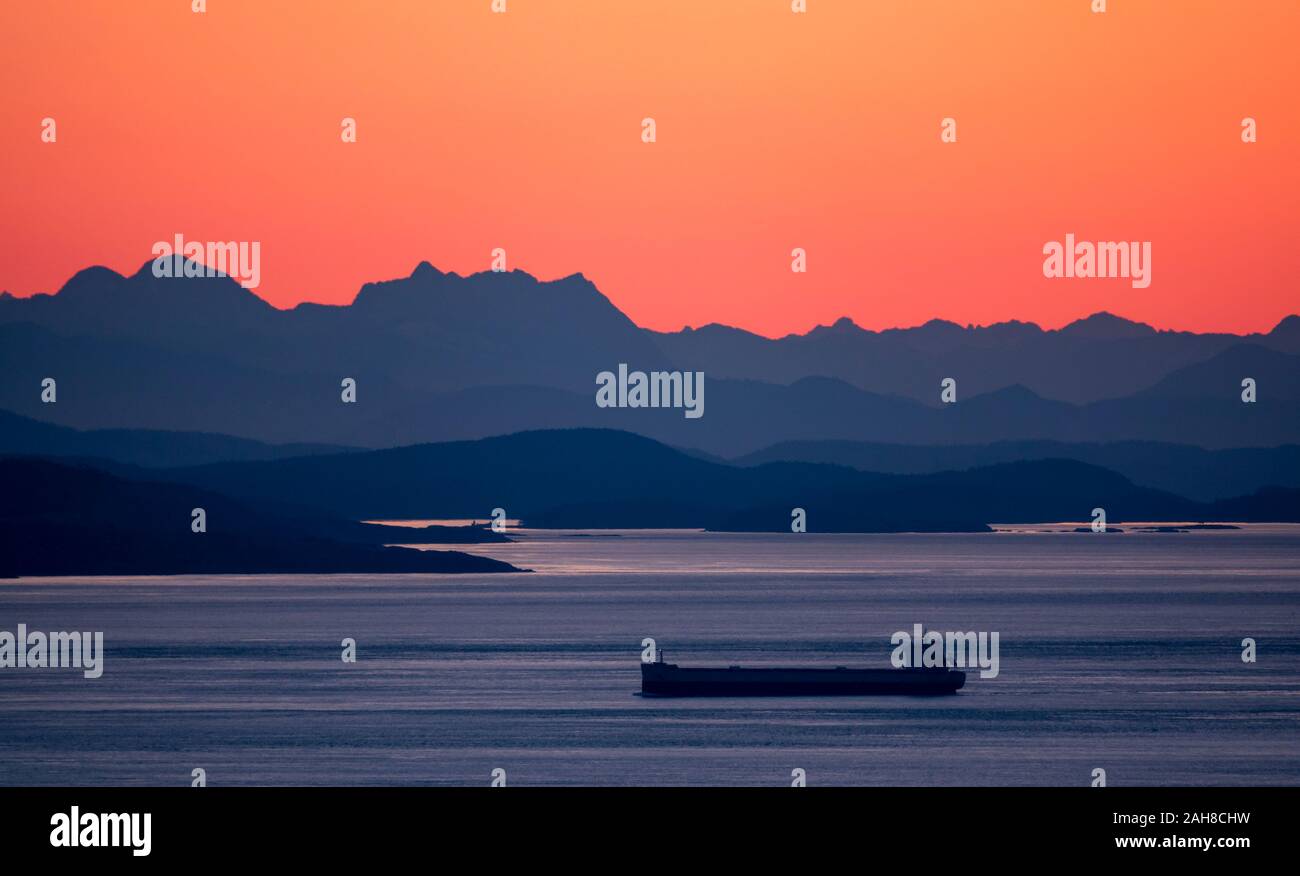 A ship in Haro Strait at dawn with San Juan Island and the North ...