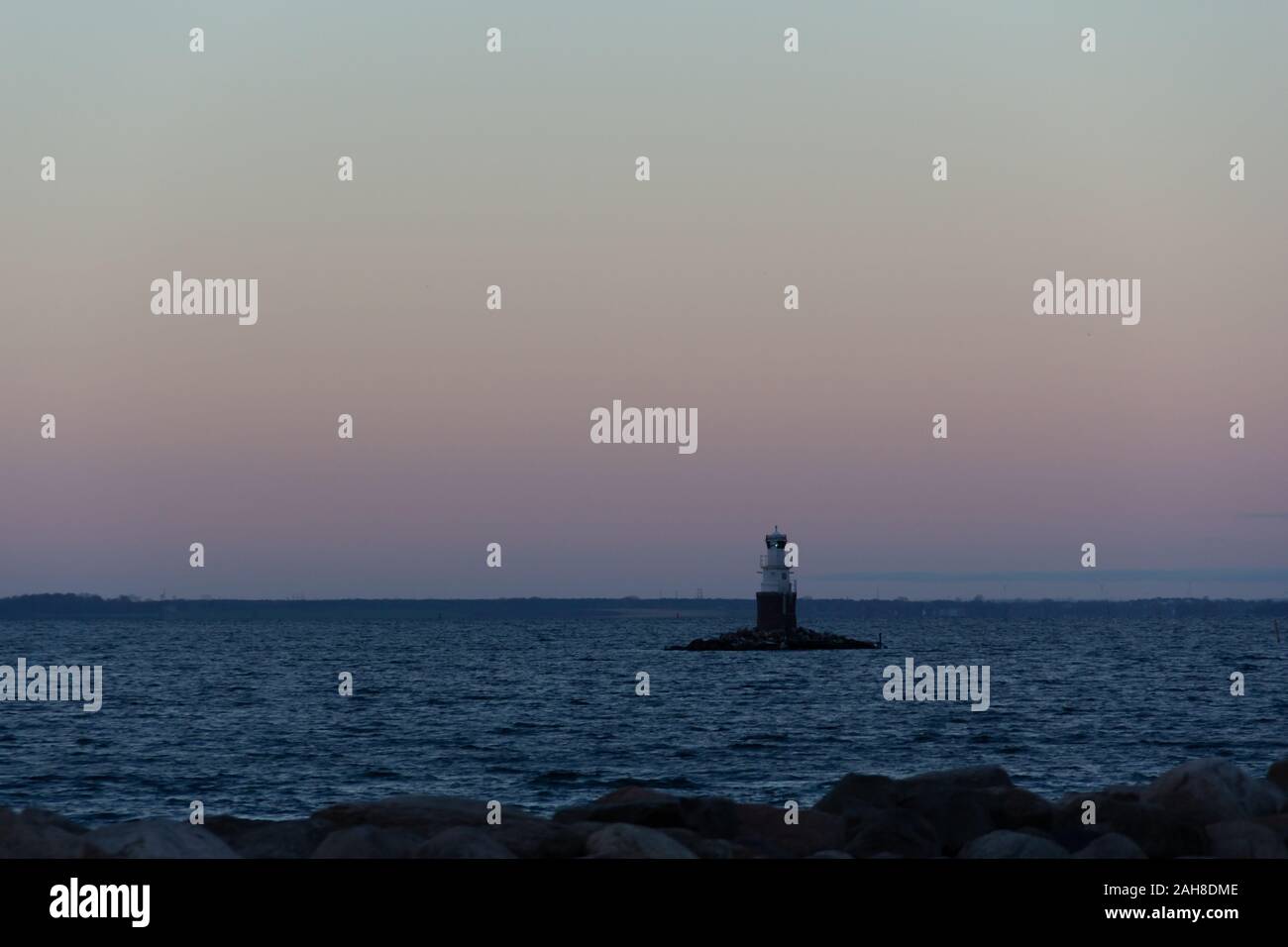 A lighthouse outside Malmö, Sweden, during a winter sunset Stock Photo ...