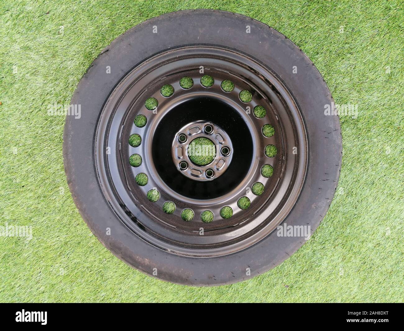 An emergency wheel laying on the grass, ready for the event of a ...
