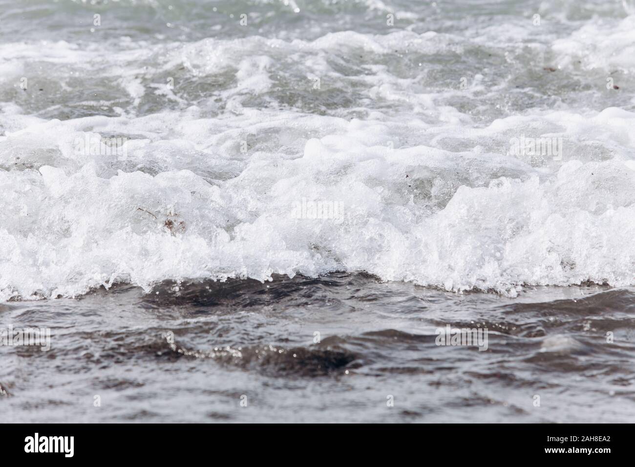 Waves on the beach. A surge of water ashore Stock Photo - Alamy