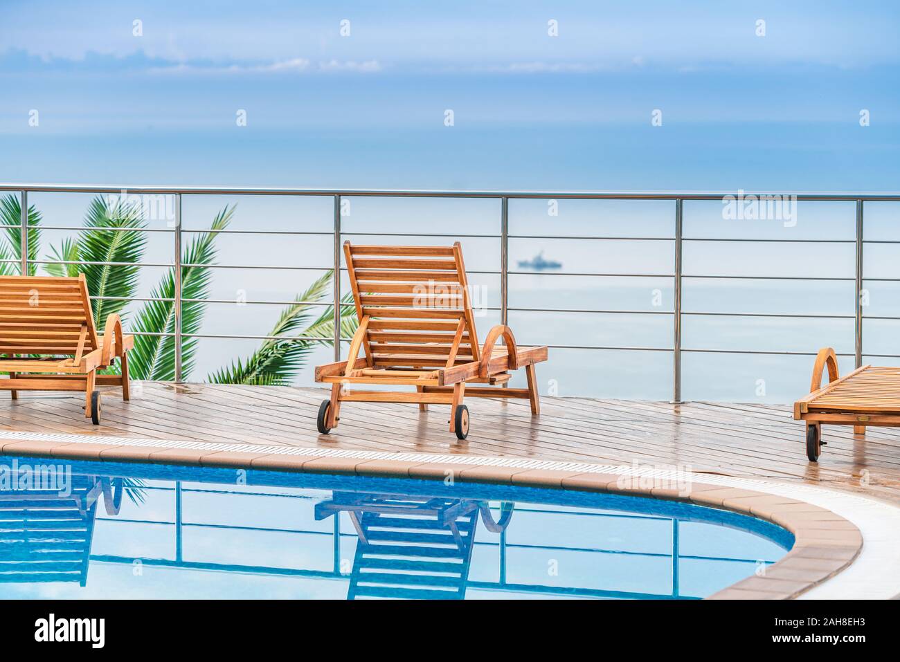 chair around outdoor swimming pool in hotel resort neary sea and beach ...