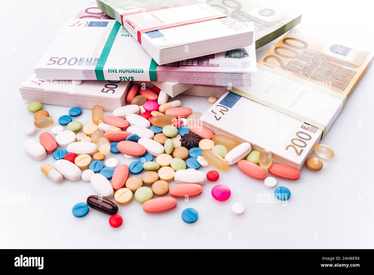Multicolored tablets with Euro banknotes on white background Stock ...