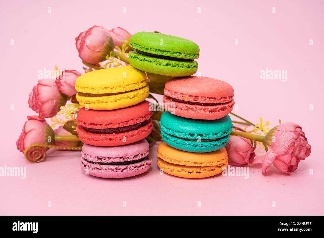 tasty colorful macarons on pink background Stock Photo - Alamy