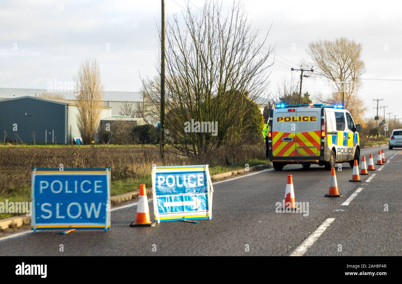 Police have coned off a lane of a busy main road, in the United Kingdom ...