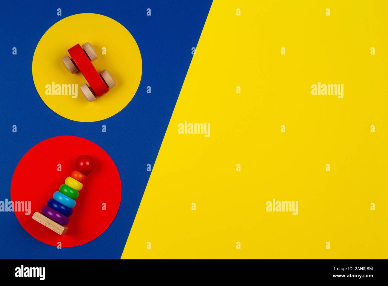 Baby kids toys background. Wooden stacking pyramid tower and red toy ...