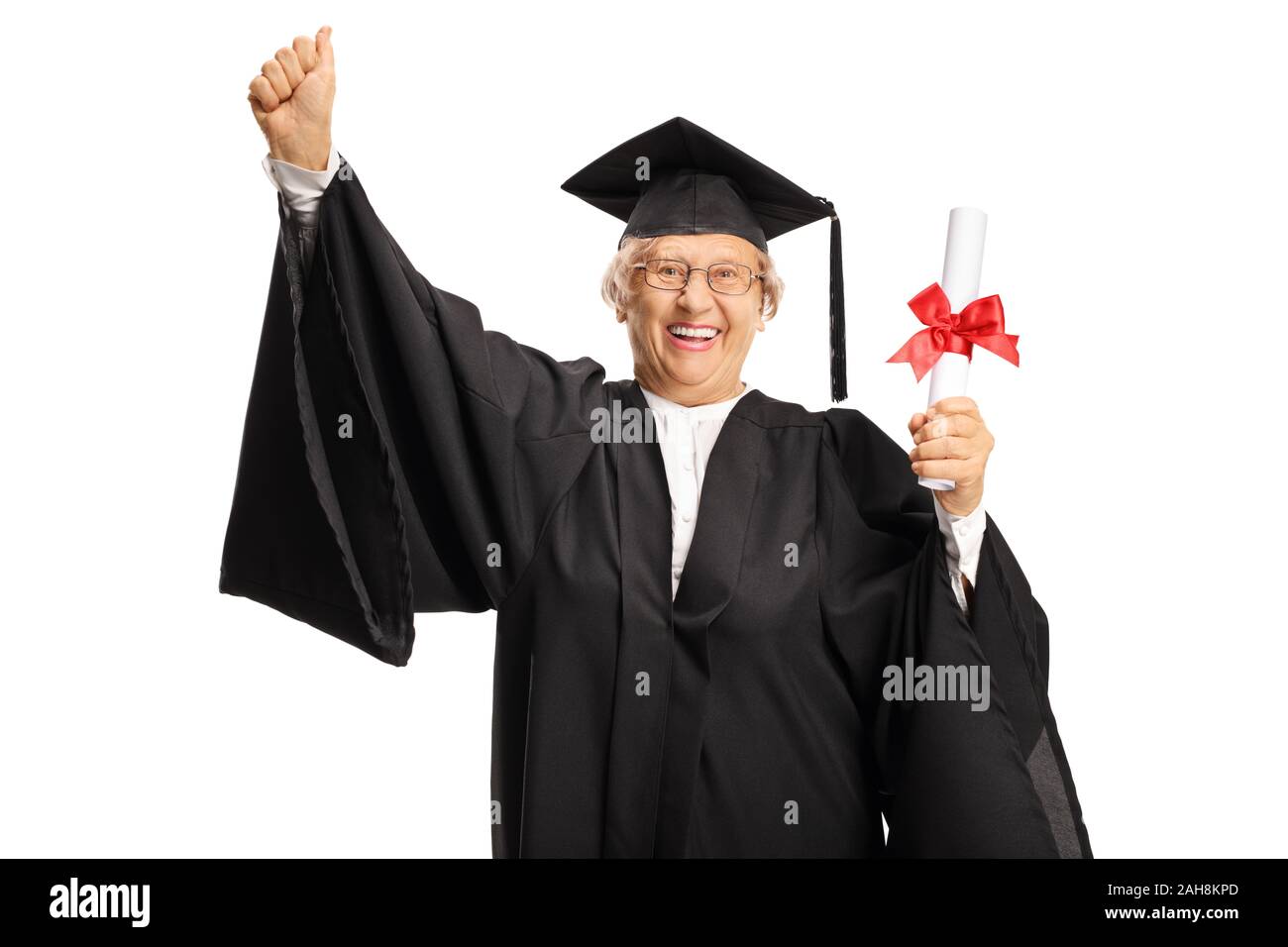Happy elderly woman in a graduation gown holding a diploma and ...