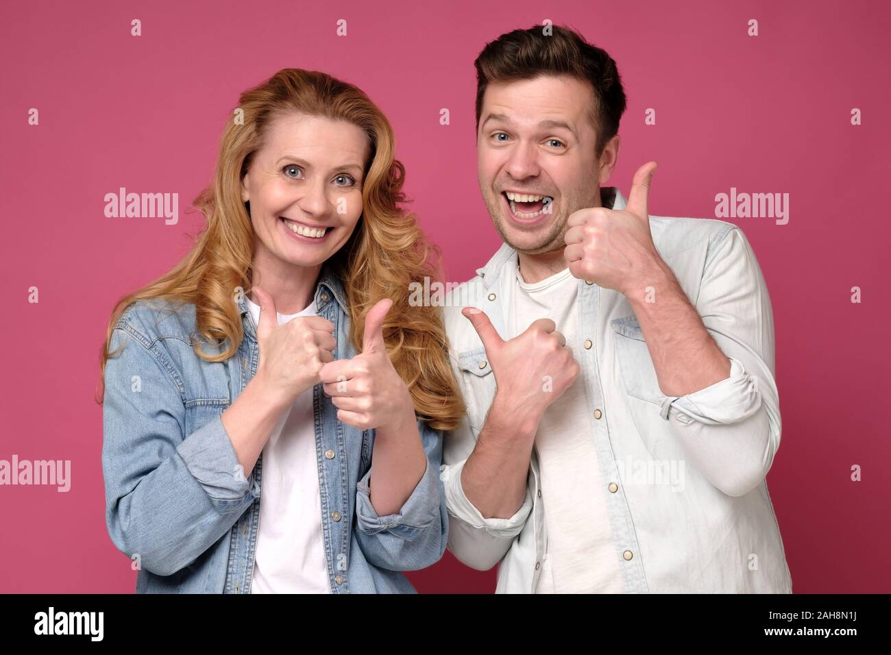 Sister and brother approving doing positive gesture with hand, thumbs ...