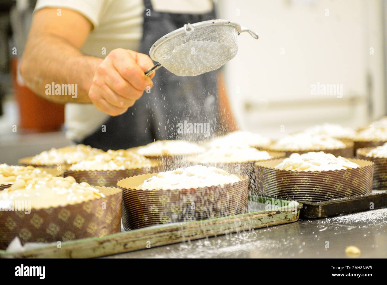 Adult strong man baking milanese traditional panettone is an Italian ...