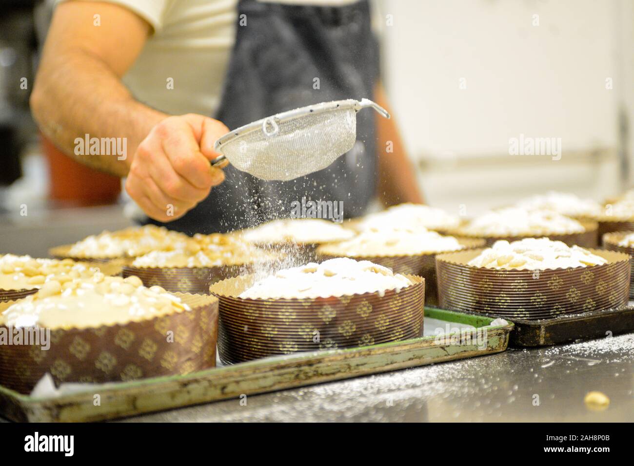 Adult strong man baking milanese traditional panettone is an Italian ...