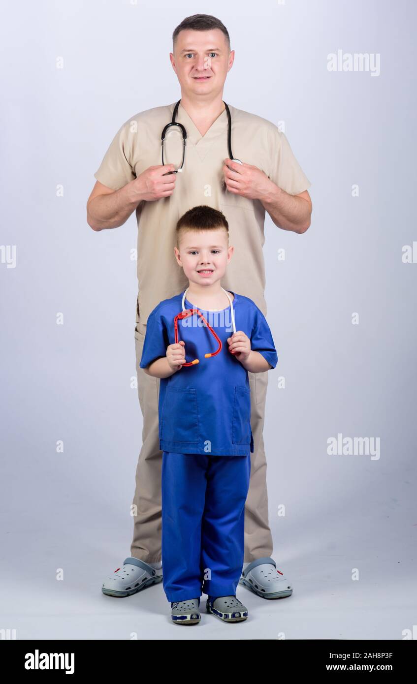 Future profession. Want to be doctor as dad. Cute kid play doctor game ...