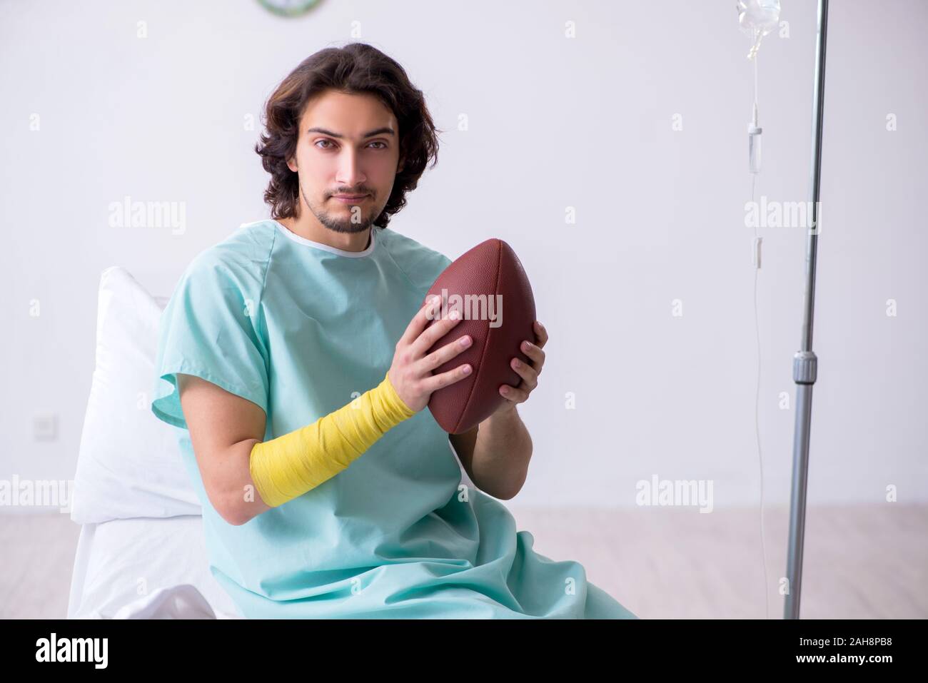 The young man staying in hospital in transfusion concept Stock Photo ...