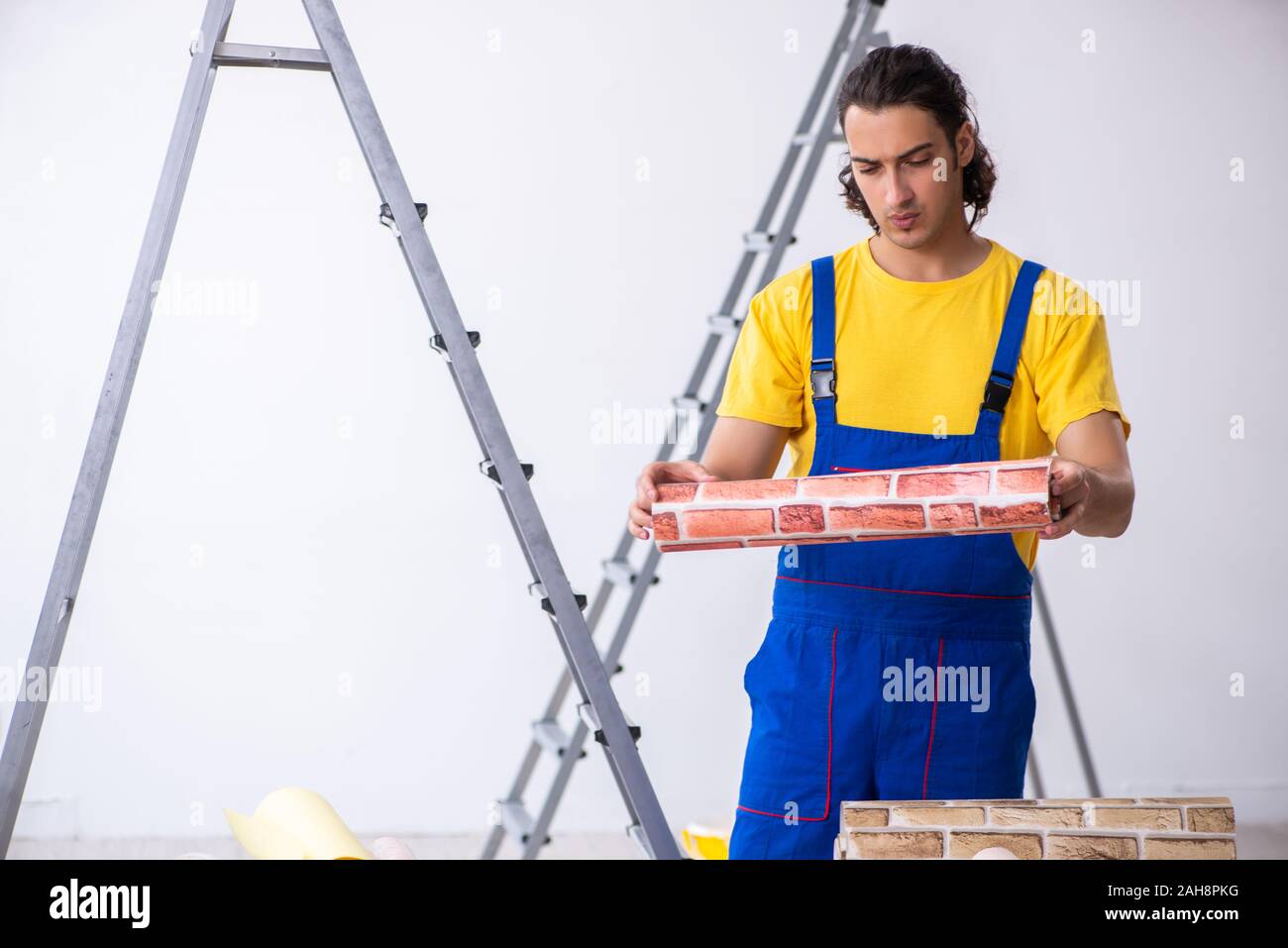 Young man contractor doing renovation hi-res stock photography and ...