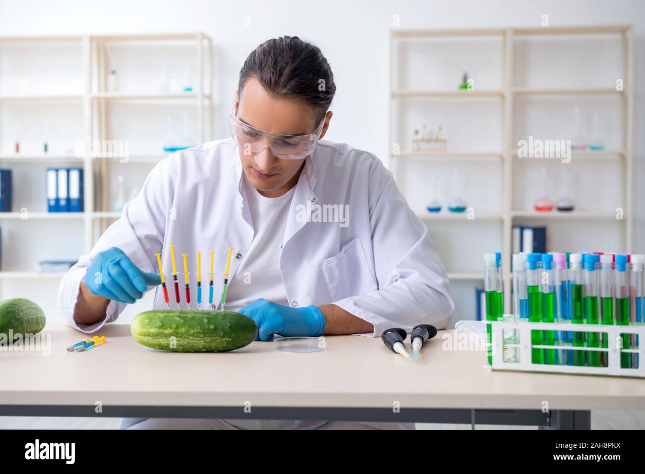 The male nutrition expert testing vegetables in lab Stock Photo - Alamy