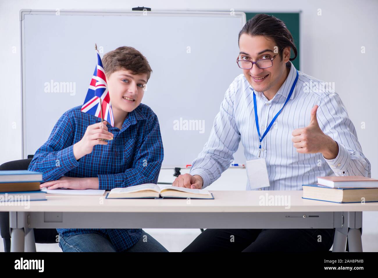 The male english teacher and boy in the classroom Stock Photo - Alamy