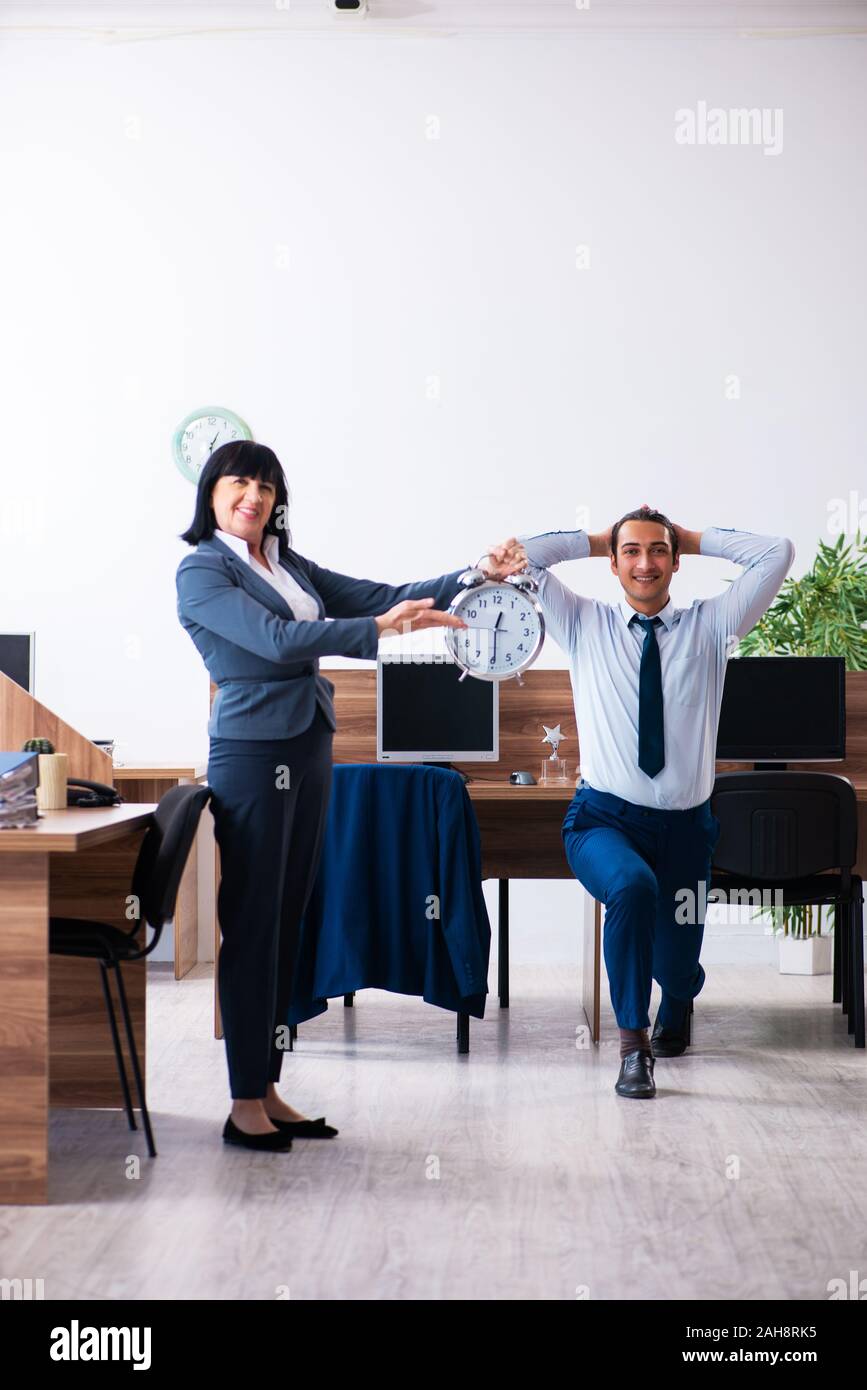 The male employee doing sport exercises in the office Stock Photo - Alamy