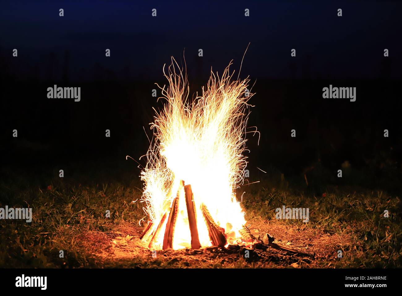 Bonfire with sparks and strong fire at night in total darkness Stock ...