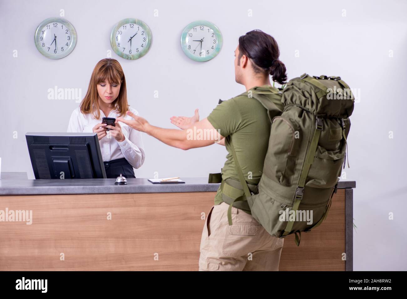 The young man at the hotel reception Stock Photo - Alamy