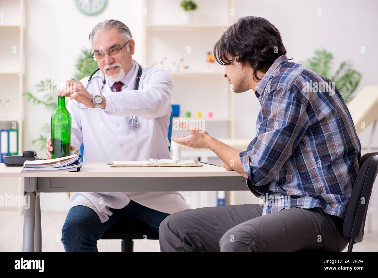 The young male alcoholic visiting old doctor Stock Photo - Alamy