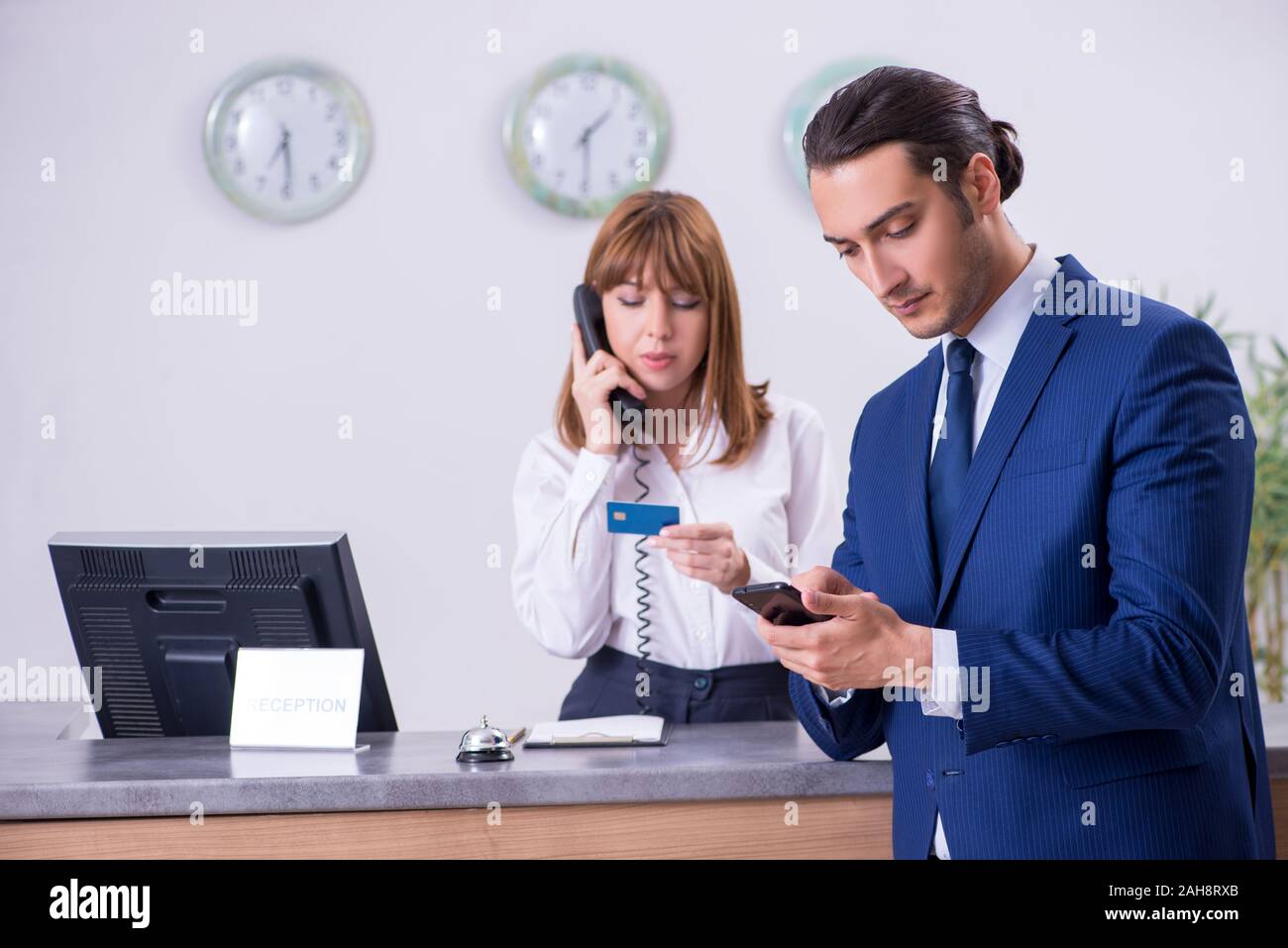 Businessman tourism talking telephone reception counter in hotel hi-res ...