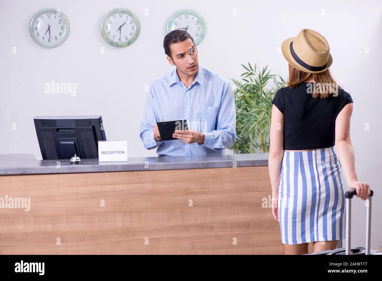 The young woman at hotel reception Stock Photo - Alamy