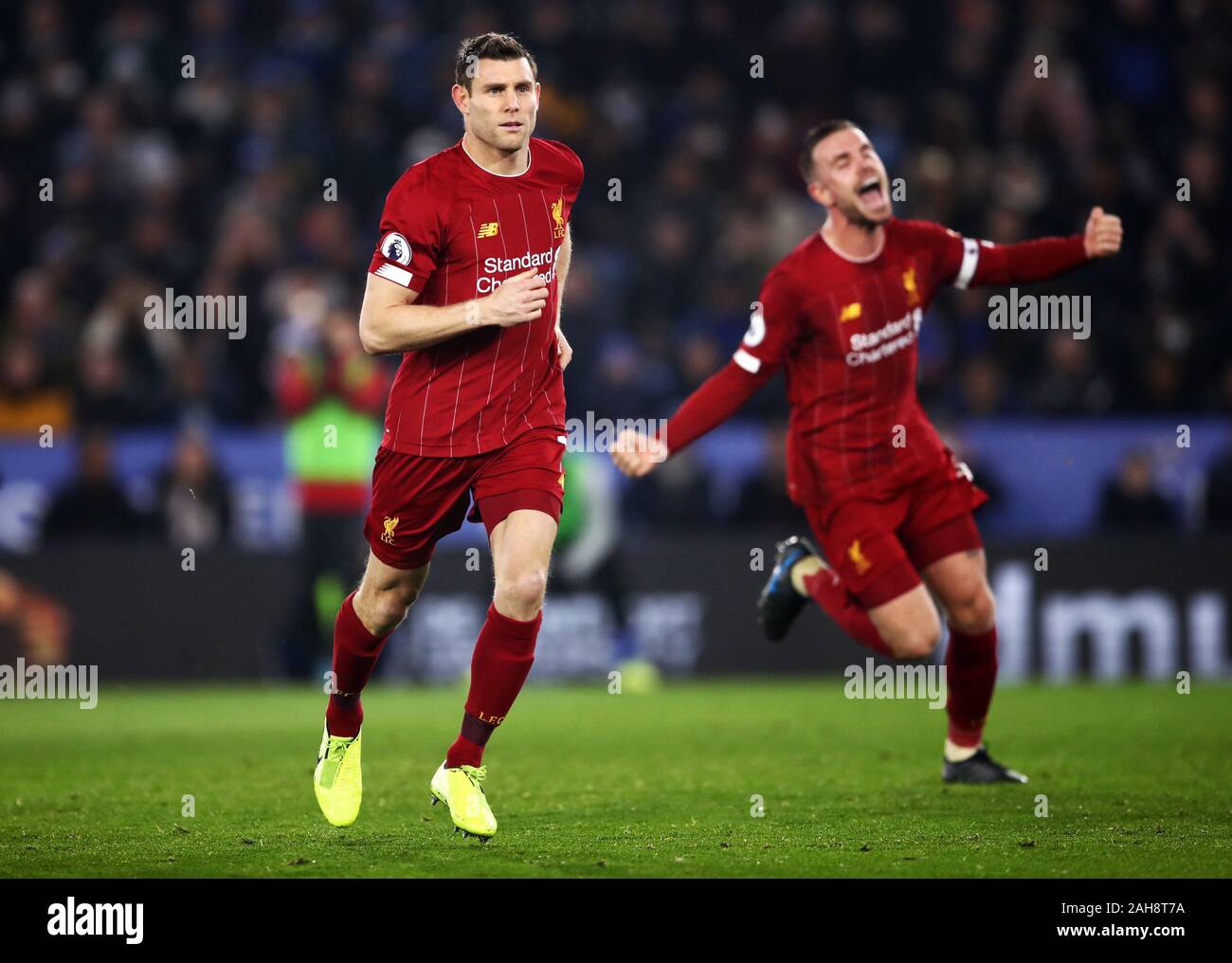 Liverpool's James Milner (left) celebrates scoring his side's second ...